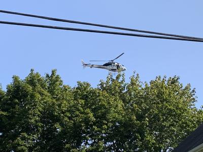 Low-flying helicopter in Mansfield inspecting train track power lines ...