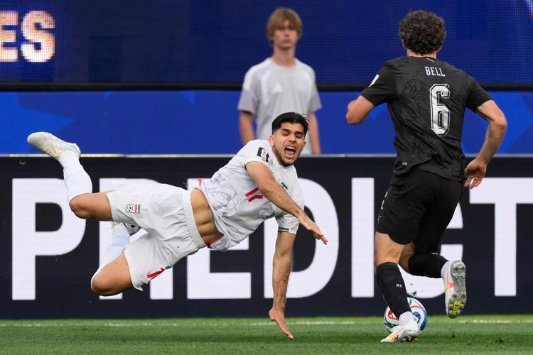 Iran opens its politically charged World Cup by playing to a 2-2 draw ...