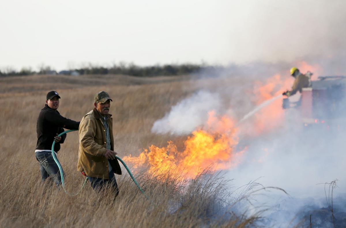 Photos: Thousands flee deadly wildfires across four states | National ...
