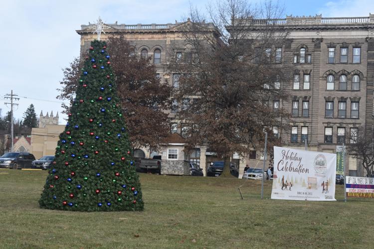 City workers erect 18-foot Christmas tree in downtown | Local News ...