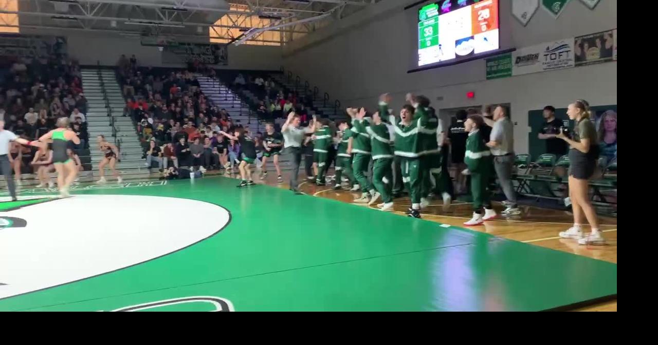 Kelly Walsh wrestlers and coaches celebrate William Alt's victory on Thursday.