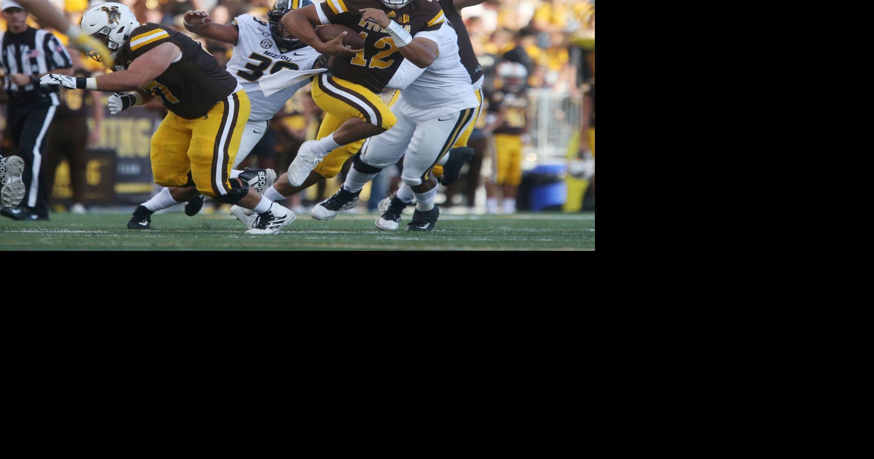 Wyoming QB Sean Chambers gets some encouragement from his competition