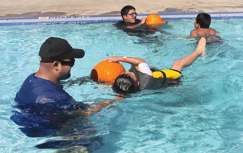 Swimmers dive into floating pumpkin patch at Joe Wilson Pool | Tracy ...