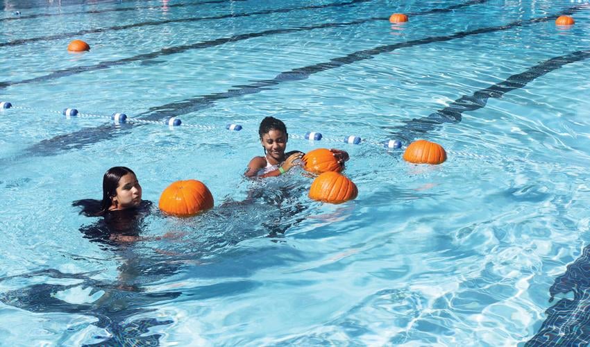 Swimmers dive into floating pumpkin patch at Joe Wilson Pool | Tracy ...