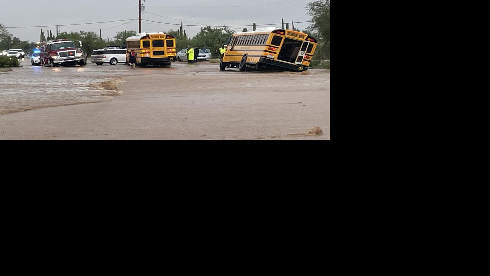 Students rescued from school bus stuck on storm-damaged road | Local ...