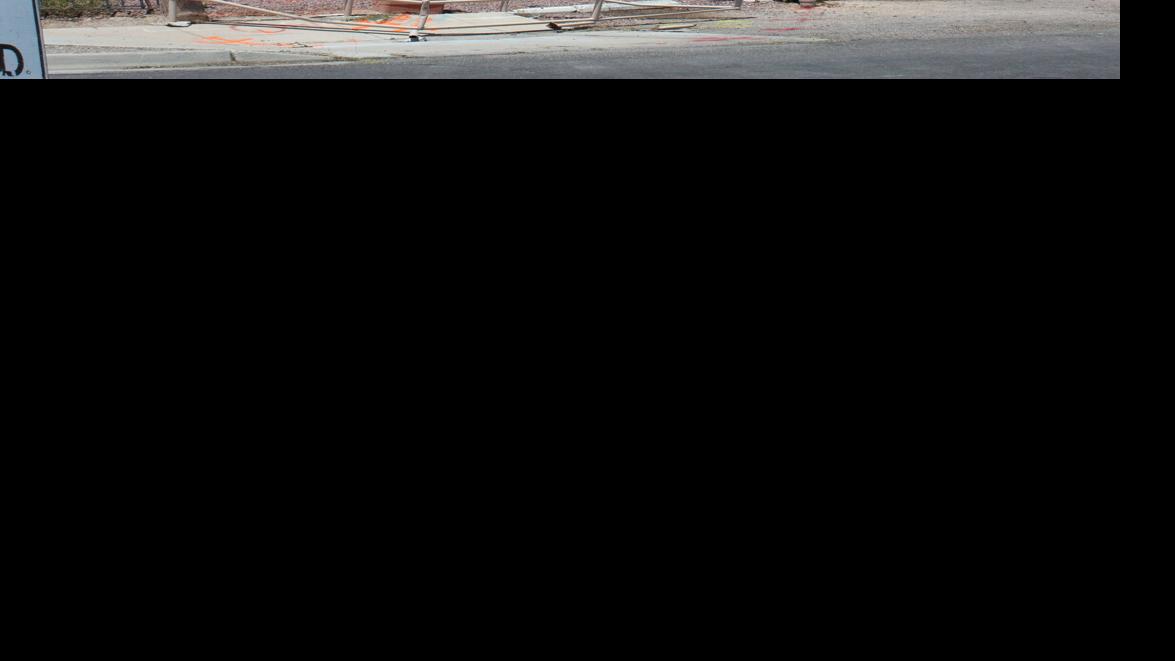 Utility pole blown over onto building
