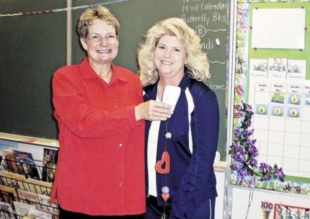Teacher of primary grades guides students to kindness