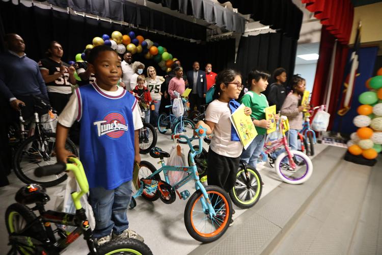 Homegrown football hero returns to Waco ISD bearing bikes for kids