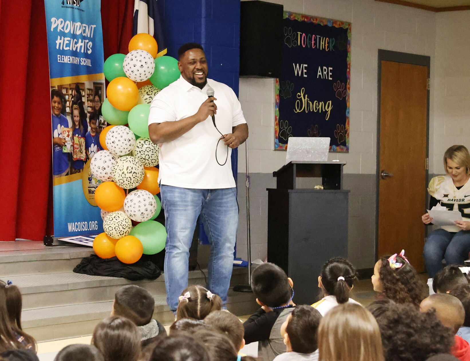 Homegrown football hero returns to Waco ISD bearing bikes for kids