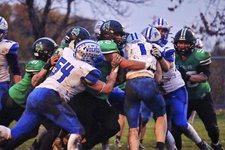 Cowboys drag Wolves through the mud in 36-0 win, clinching No. 2 seed ...