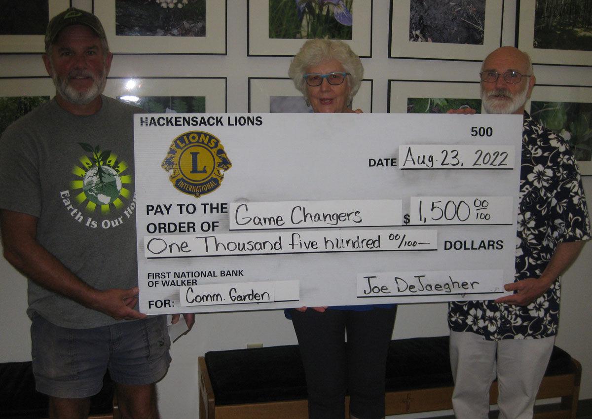 Presenting the check to Jim Etzel (from left) and Karen Holle is Don ...