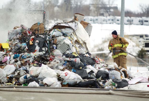 Smoldering mess caused by garbage truck fire in Cedar Falls