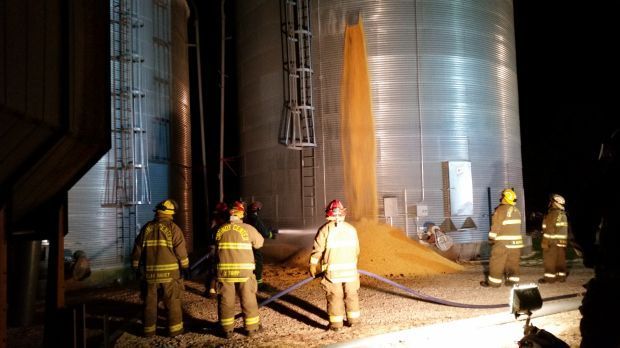 Firefighters stop flames burning inside grain bin
