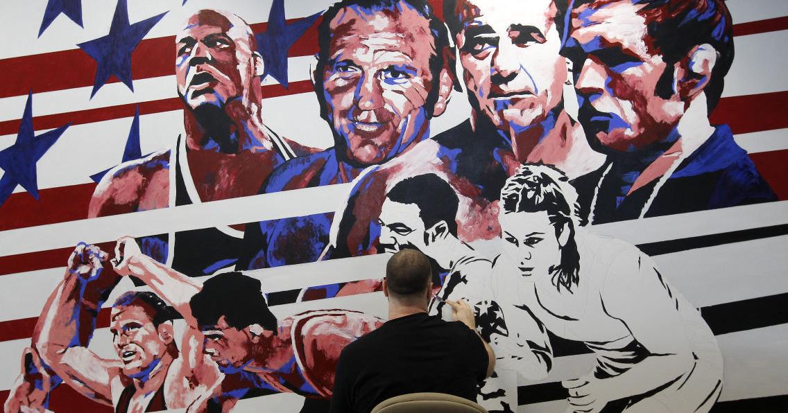 Premiere WWE portrait artist paints large mural at Dan Gable Museum