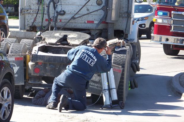 Video: Woman trapped under semi, rescued by firefighters