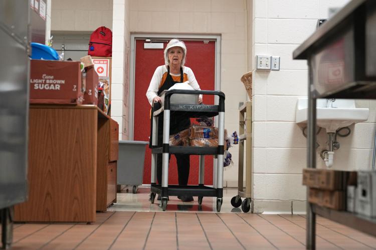 AP Photos: A cafeteria worker prepares a Thanksgiving meal to feed ...