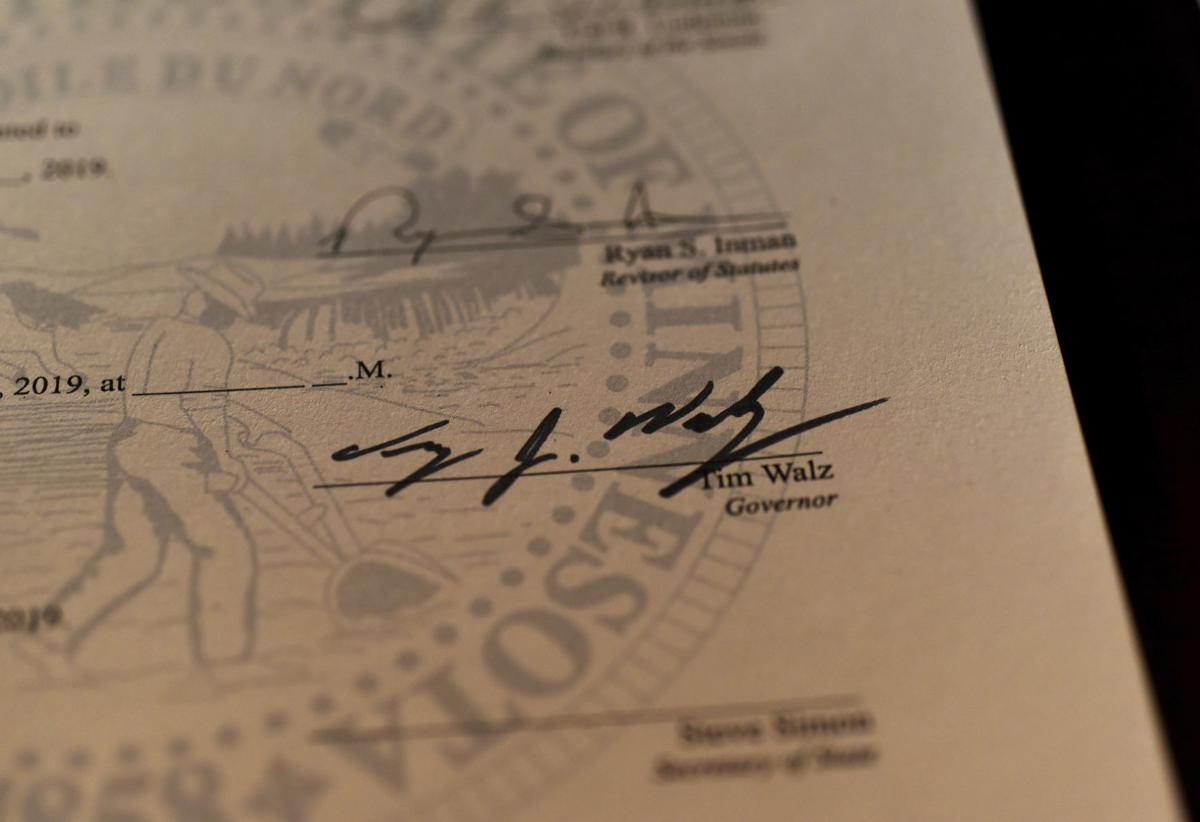 Tim Walz hails bipartisan cooperation as he signs his 1st bills