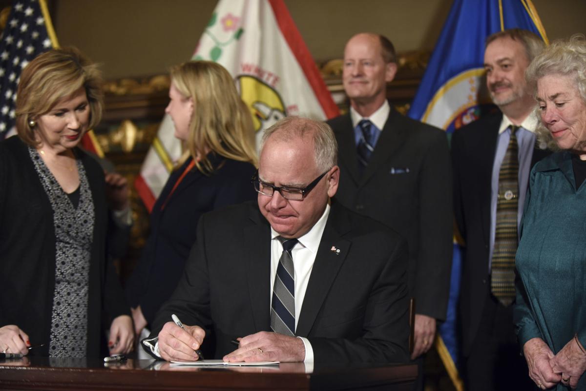 Tim Walz hails bipartisan cooperation as he signs his 1st bills