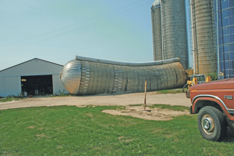 Neighbors assist in clean up of fallen silo