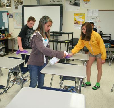 Students clean desks at school