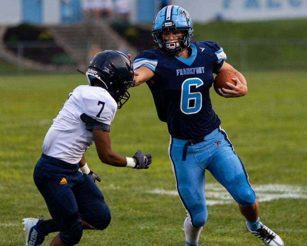 Frankfort quarterback Luke Robinette is shown stiff-arming his ...