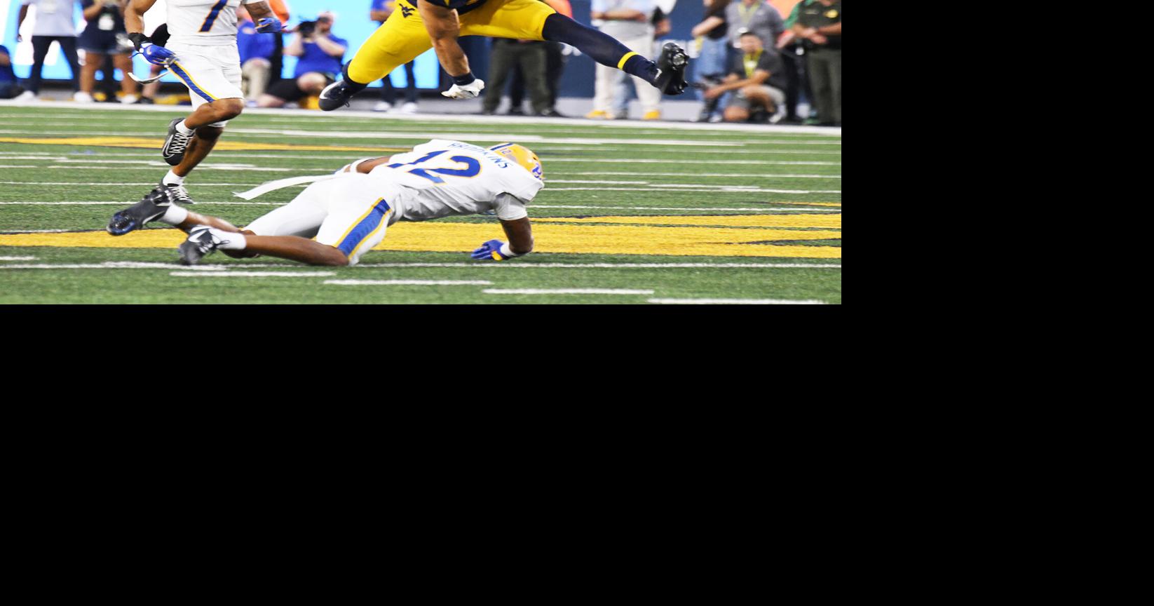 WVU football 0913 Grayson Barnes hurdles 2 front | West Virginia ...