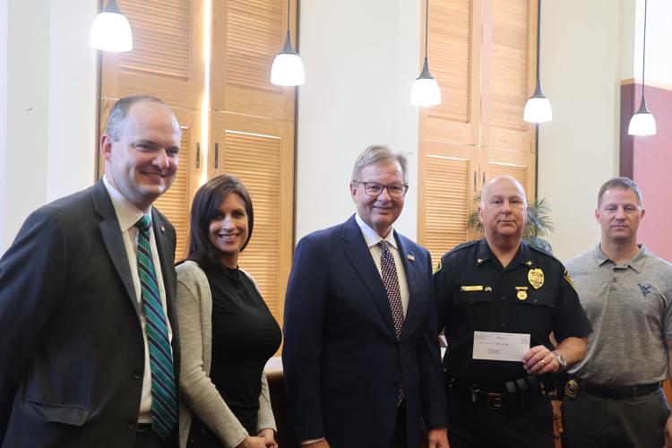 Treasurer Larry Pack delivers $1,900 check to Clarksburg Police ...
