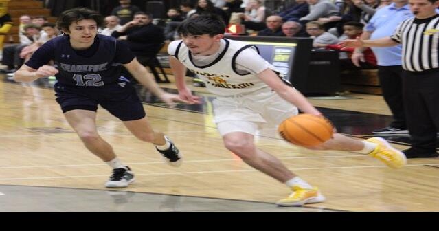 Keyser's Evan Ack takes the ball inside while being guarded by ...