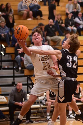 Nathan Swiger is fouled by Slaton Manko while going up for a fast break ...