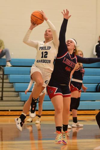 Mattie MArsh slides past Riley Pearlman under the basket.JPG | | wvnews.com